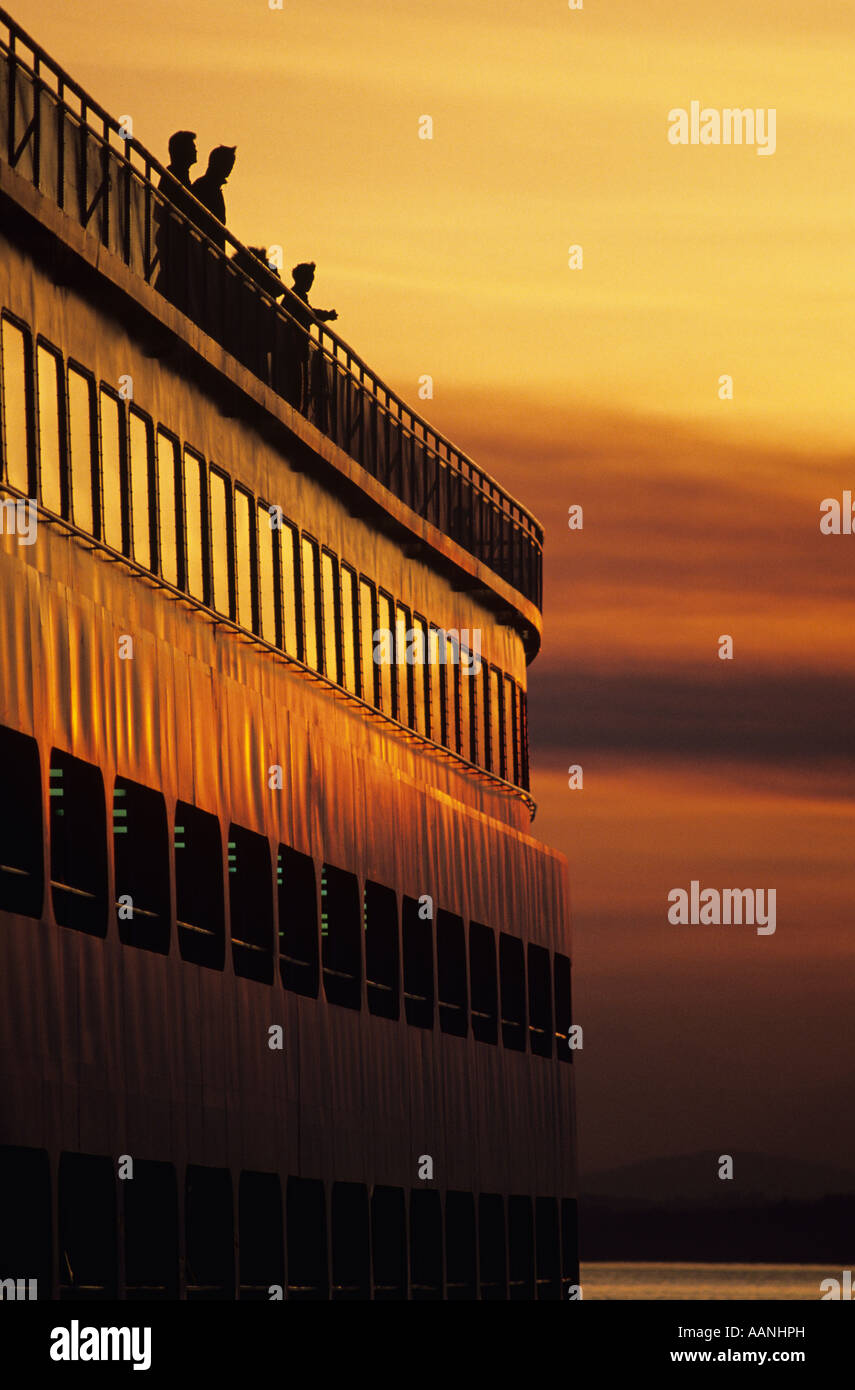 Washington State ferry at sunset with passengers looking at dramatic ...