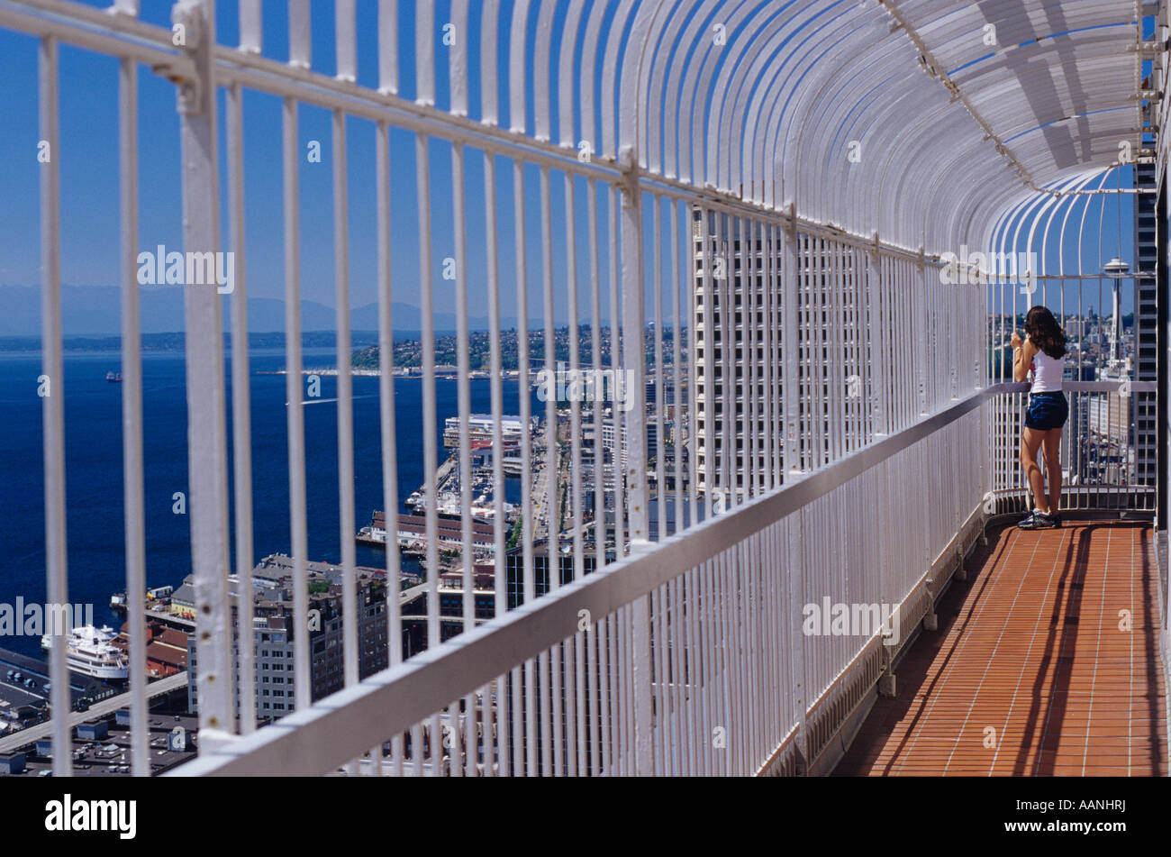 Girl looking out over the Seattle waterfront from the Historic Smith ...