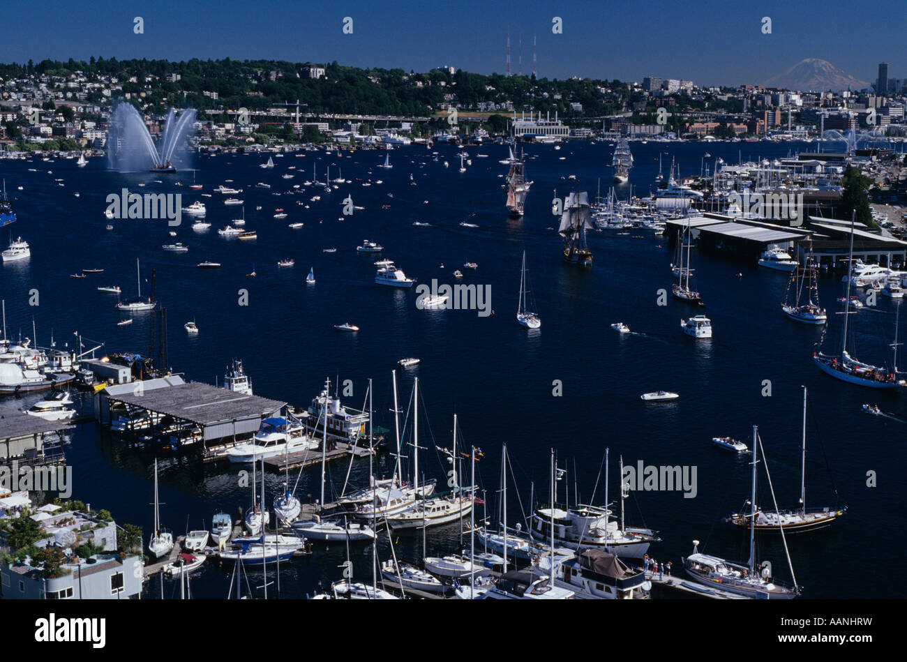 Lake Union with marinas and a flotilla of boats following a Tall ship ...