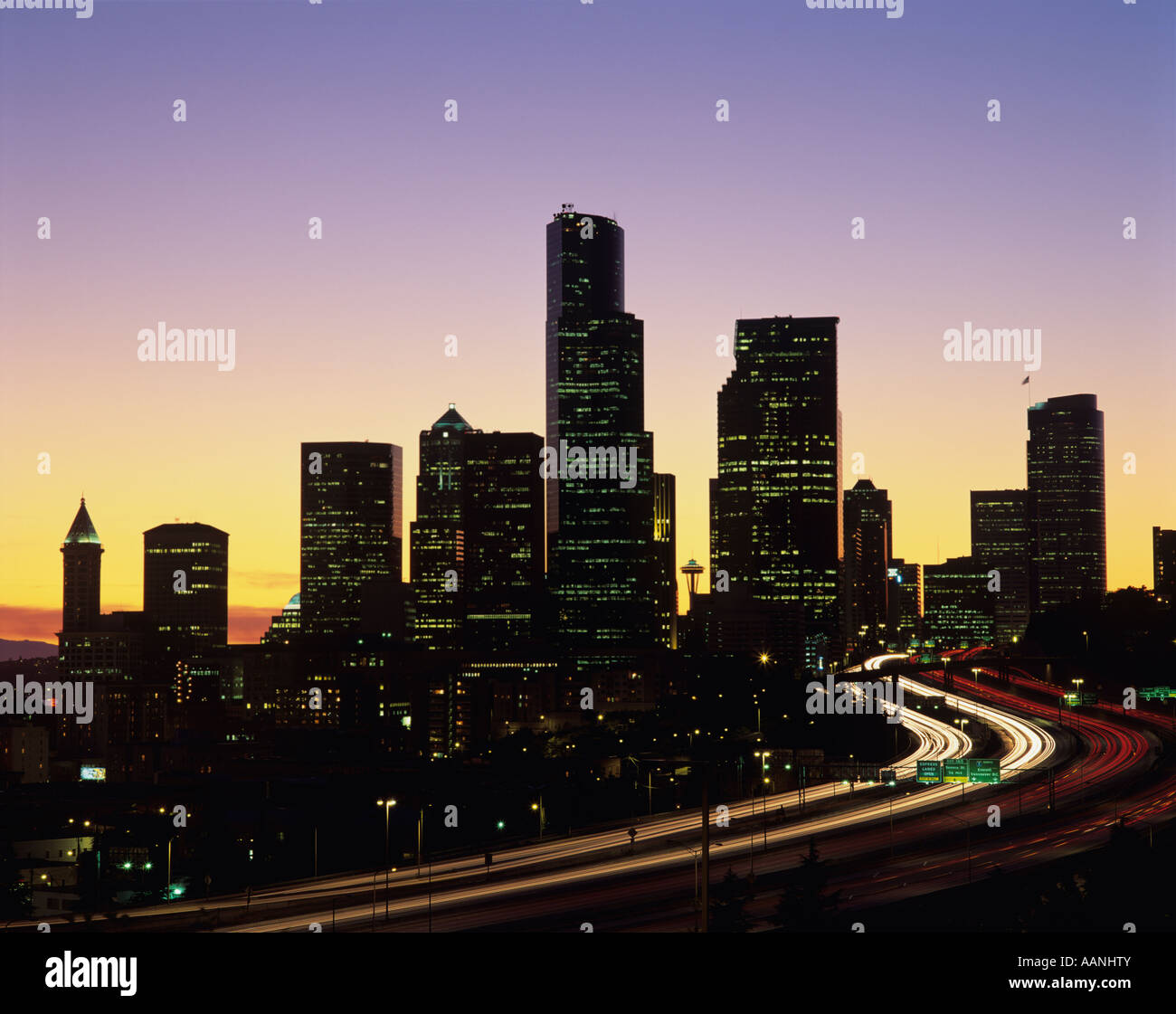 Retro image of Seattle skyline illuminated at dusk with city lights and ...