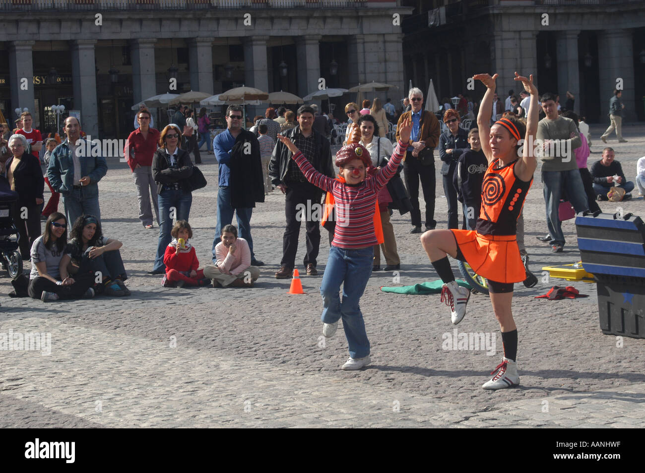 Madrid SPAIN Female street performer doing a game with a young girl in ...