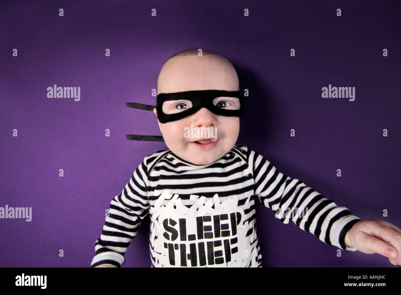 4 month old baby wearing a robbers outfit saying sleep thief Stock ...