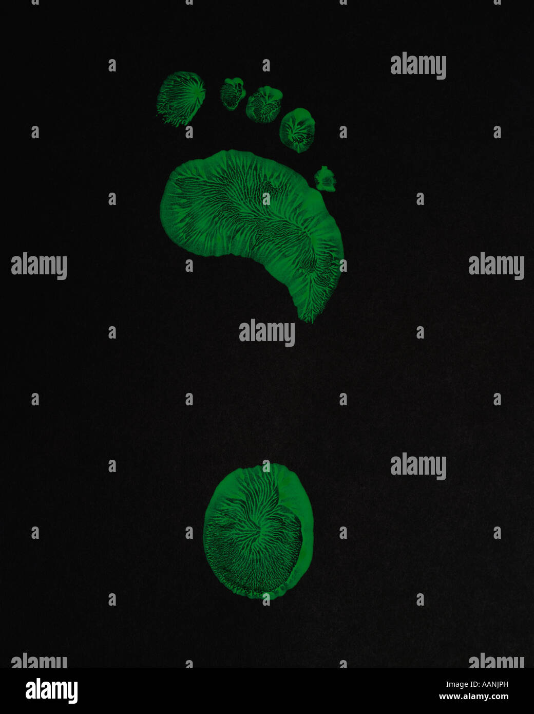 Green footprint on black background Stock Photo - Alamy