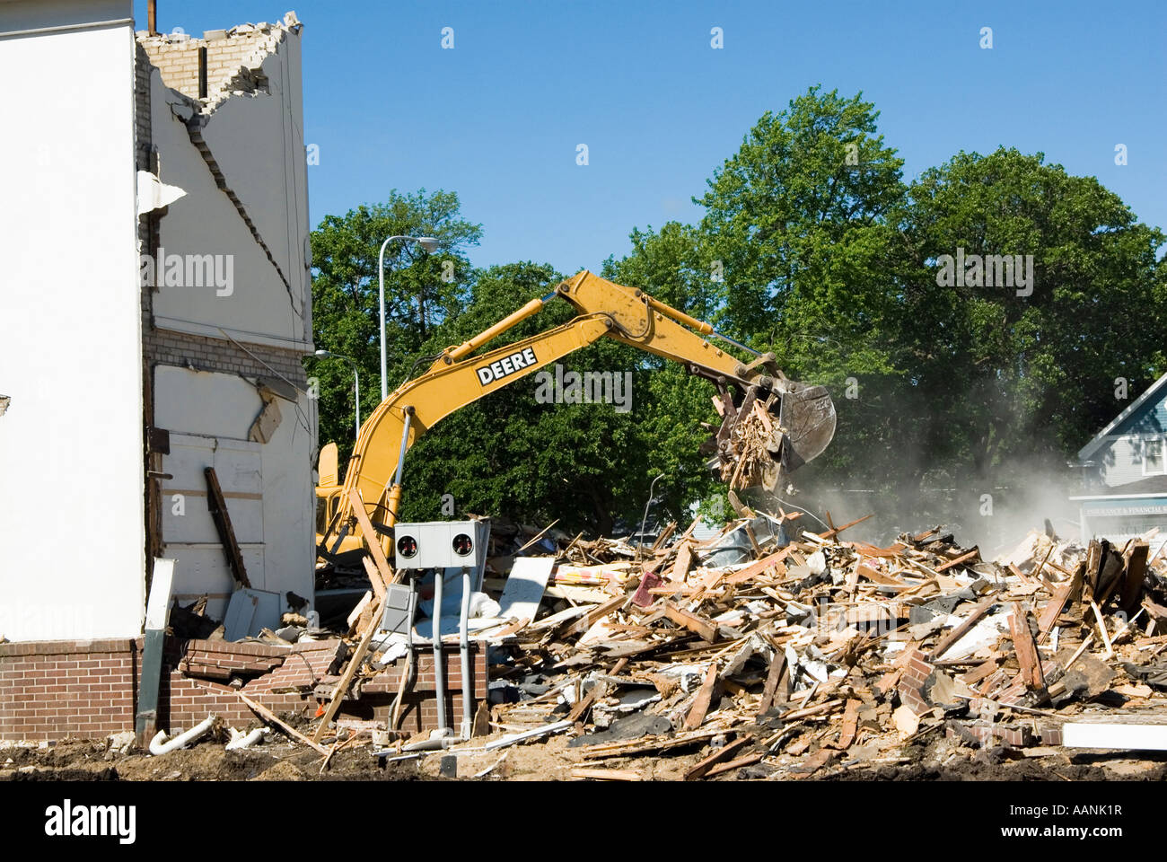 the cleanup after demolition of a wood frame building to make room for ...