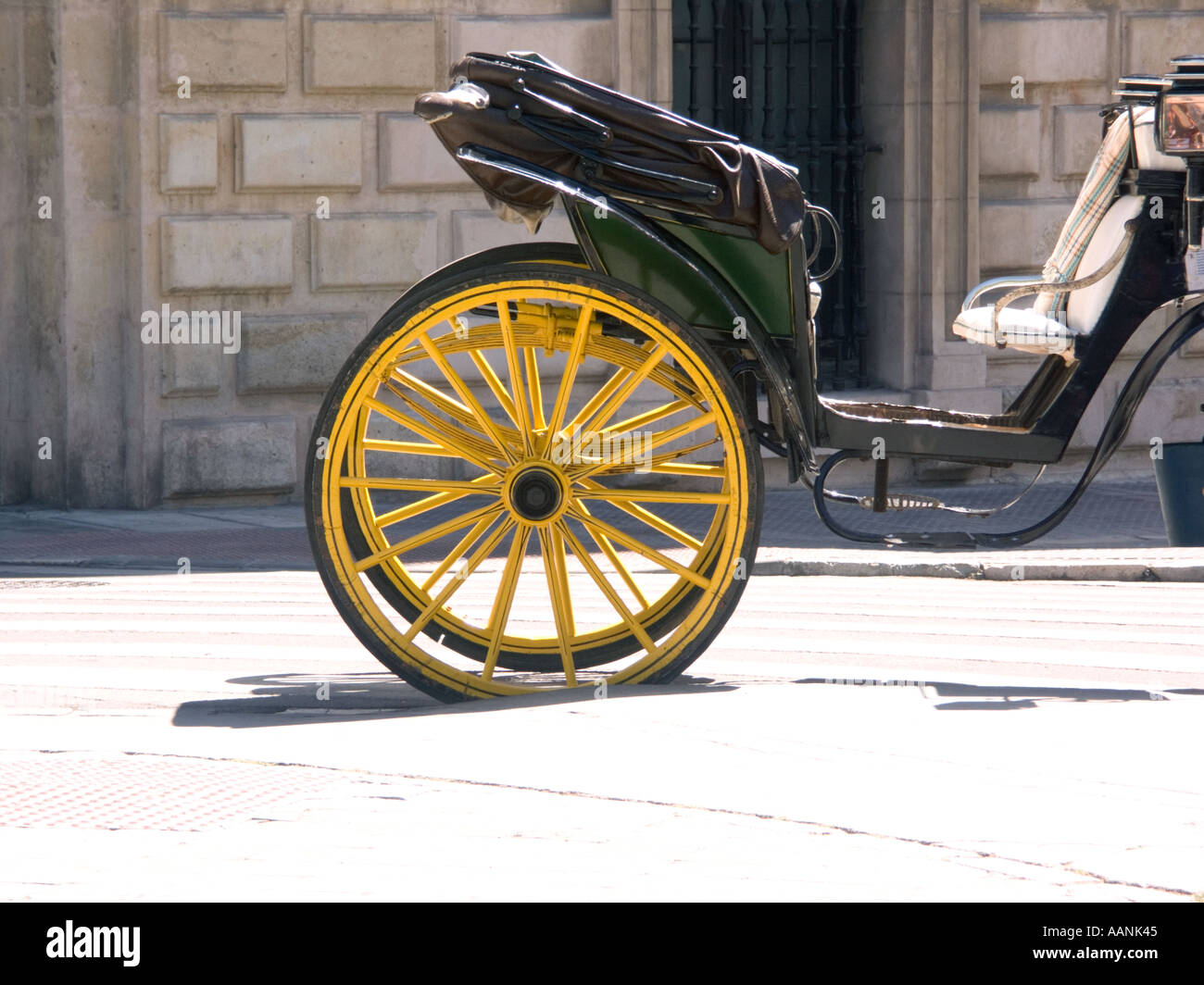Yellow carriage wheel, Spain Stock Photo - Alamy