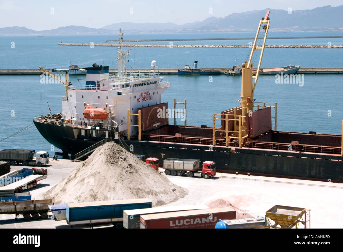 Trucks Cranes and Ships loading salt at Cagliari Harbour, Sardinia ...