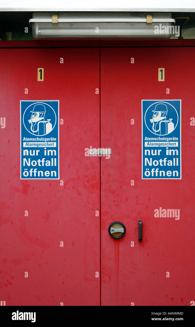 Warning sign: open only in case of emergency, blue on dark red ...