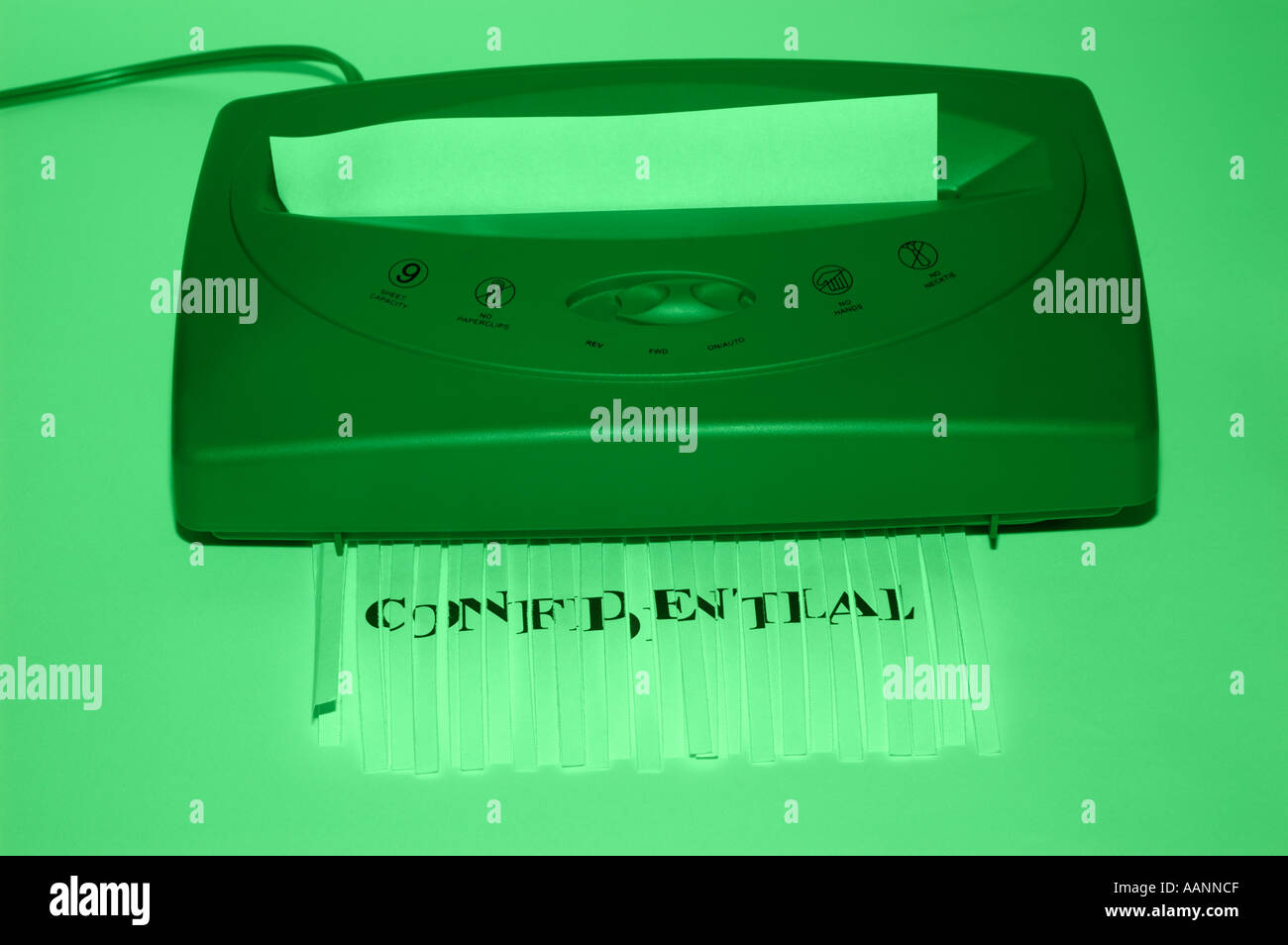 Confidential Paper with going through shredder Stock Photo - Alamy