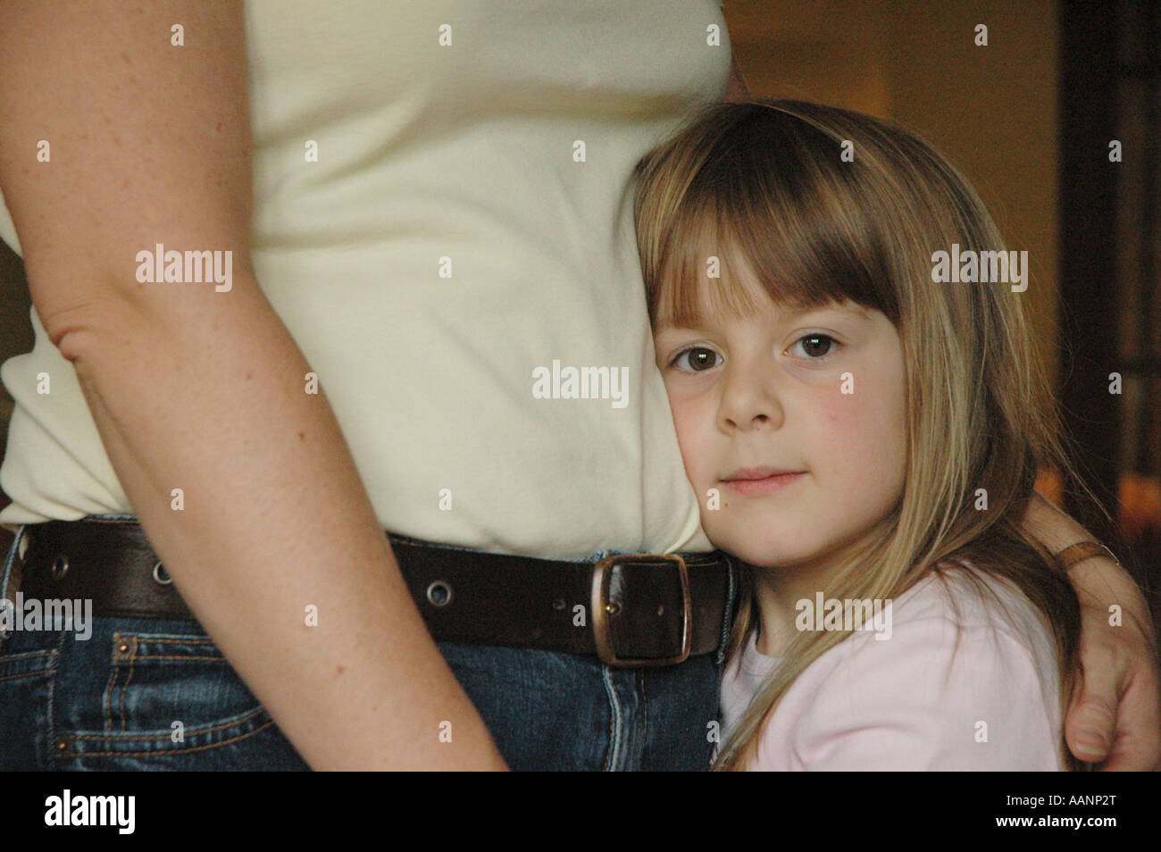 Young girl hugs into to mother for protection Stock Photo - Alamy