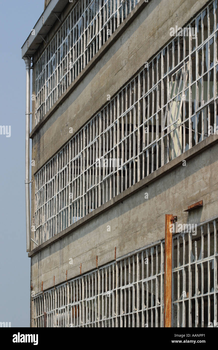 Smashed windows in derelict former industrial factory Stock Photo - Alamy