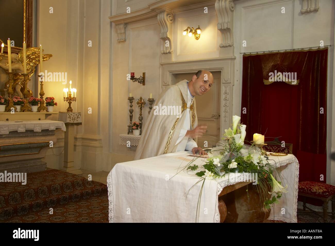 priest standing at altar Stock Photo - Alamy