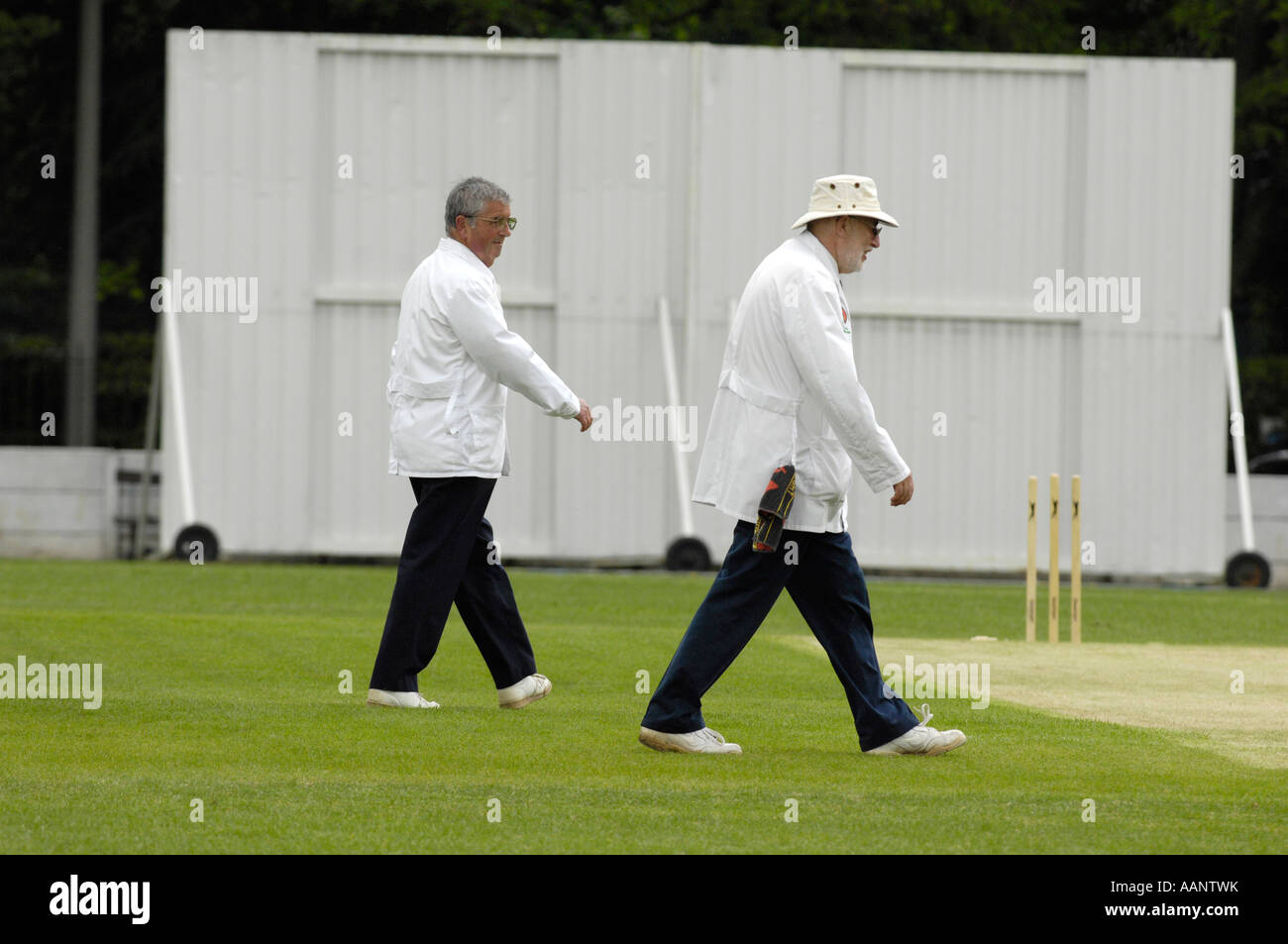 Umpires walk put at start of cricket match Stock Photo - Alamy