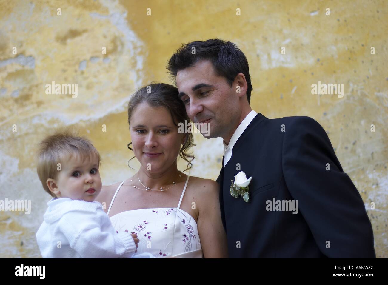 bridal couple with baby Stock Photo - Alamy