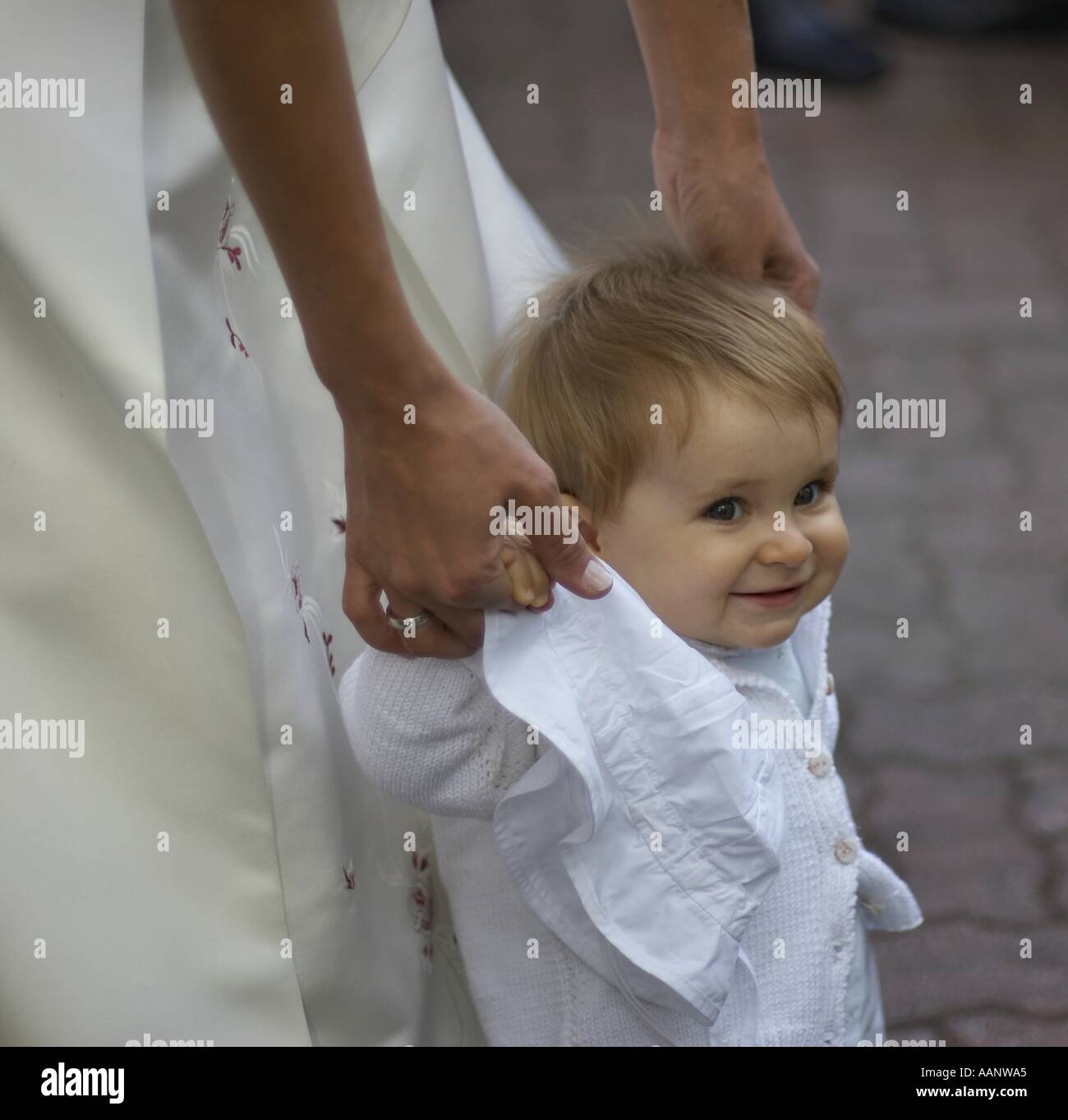 small child walking with help of mother Stock Photo - Alamy