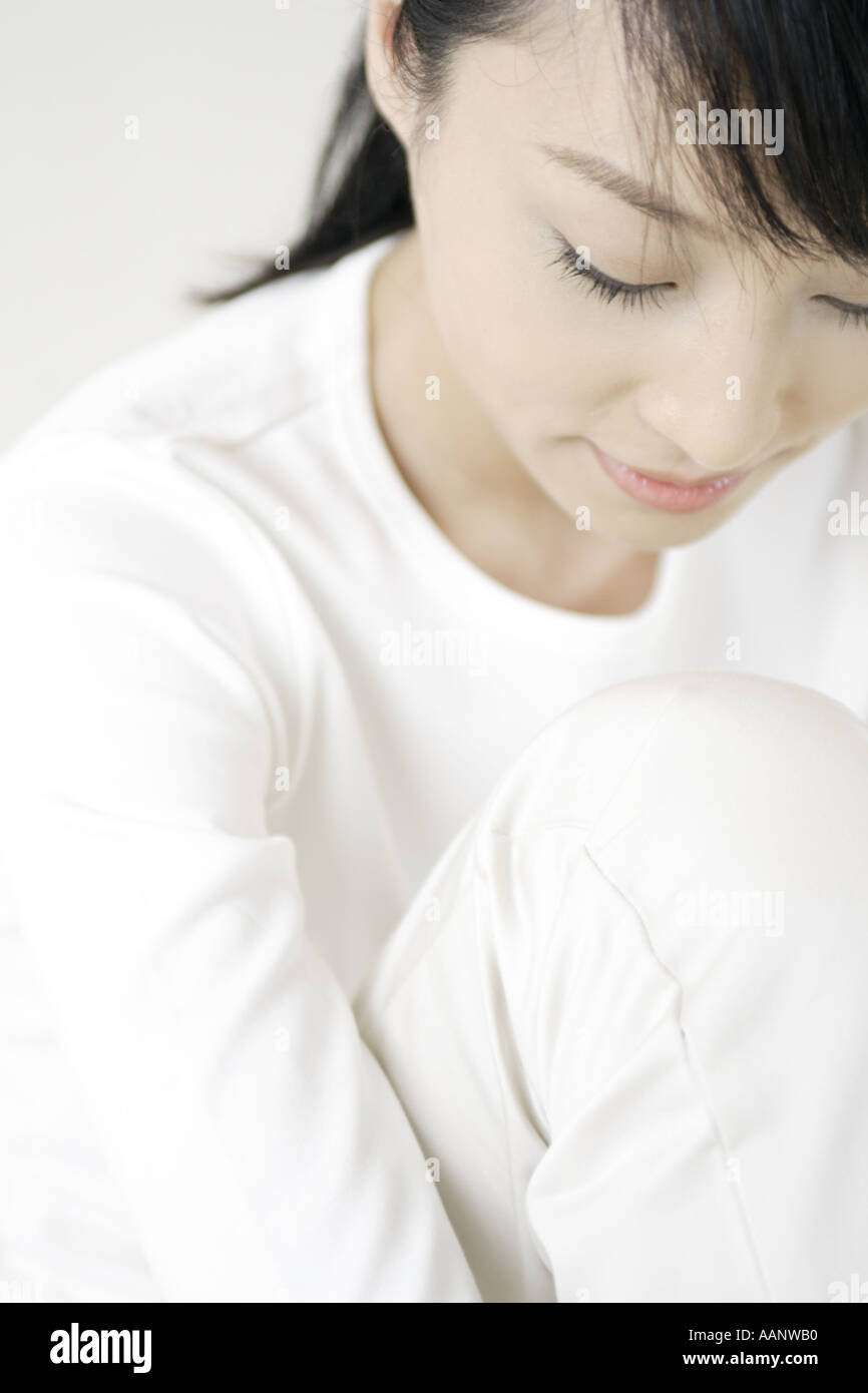 A young woman looking down Stock Photo - Alamy
