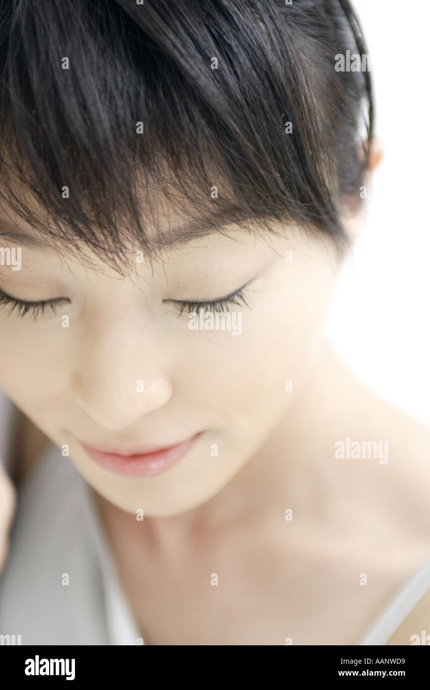A young woman looking down Stock Photo - Alamy