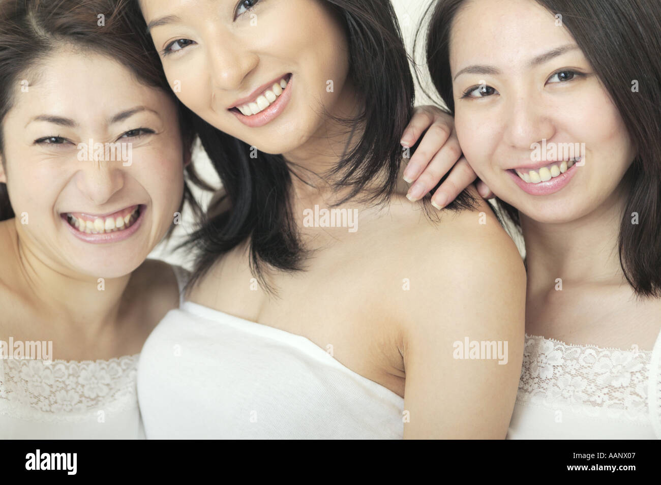 Three women smiling Stock Photo - Alamy
