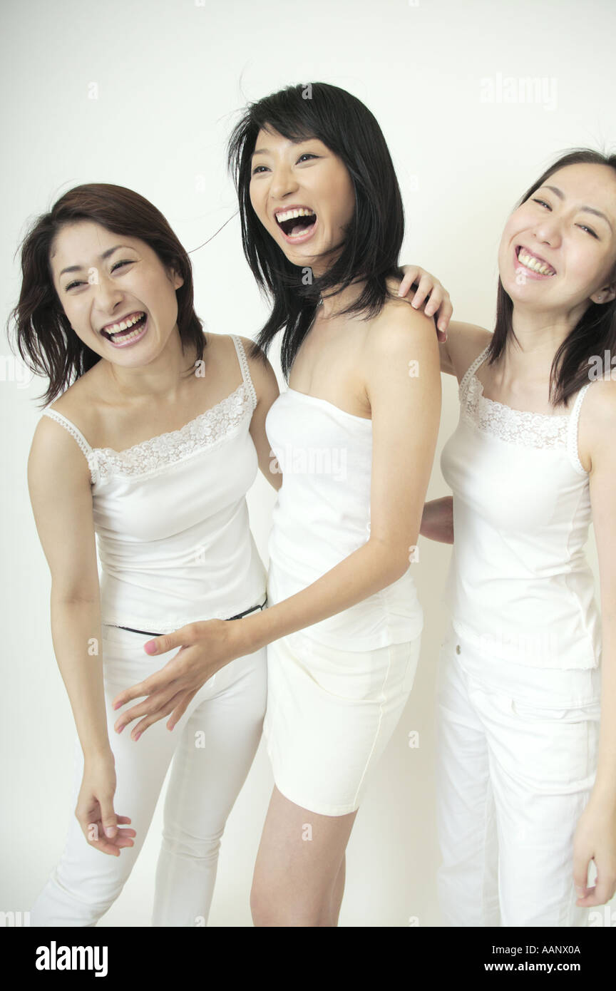 Three women smiling Stock Photo - Alamy