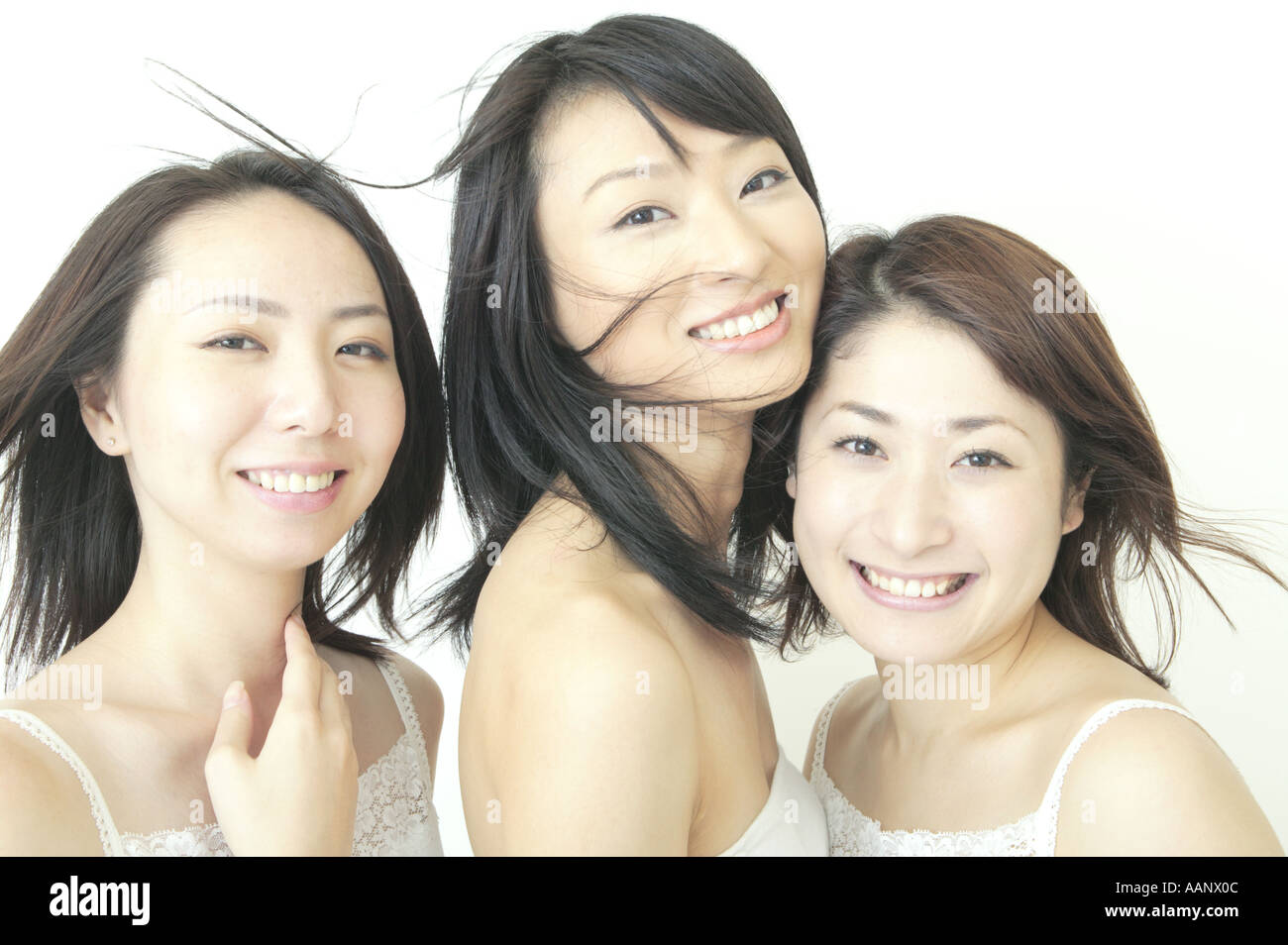 Three women smiling Stock Photo - Alamy