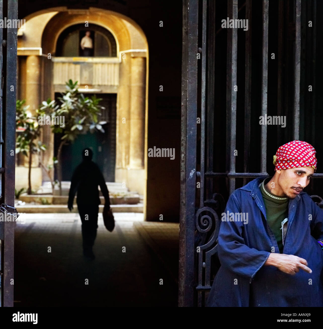 Man sitting by an iron gate in Cairo Egypt Stock Photo - Alamy