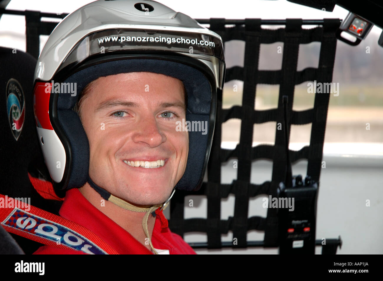 Race car driving driver smiling Stock Photo - Alamy