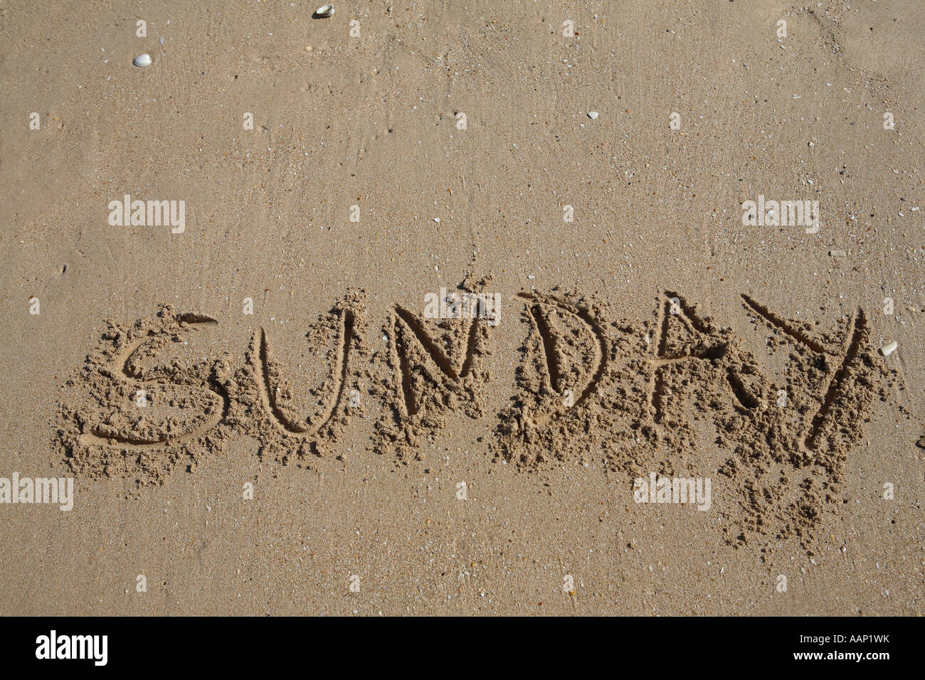 sunday written on sand, weekdays Stock Photo - Alamy