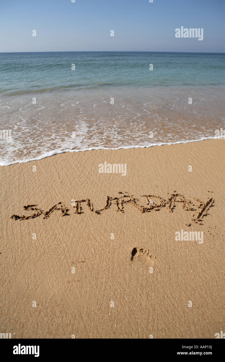saturday written on sand, weekdays Stock Photo - Alamy