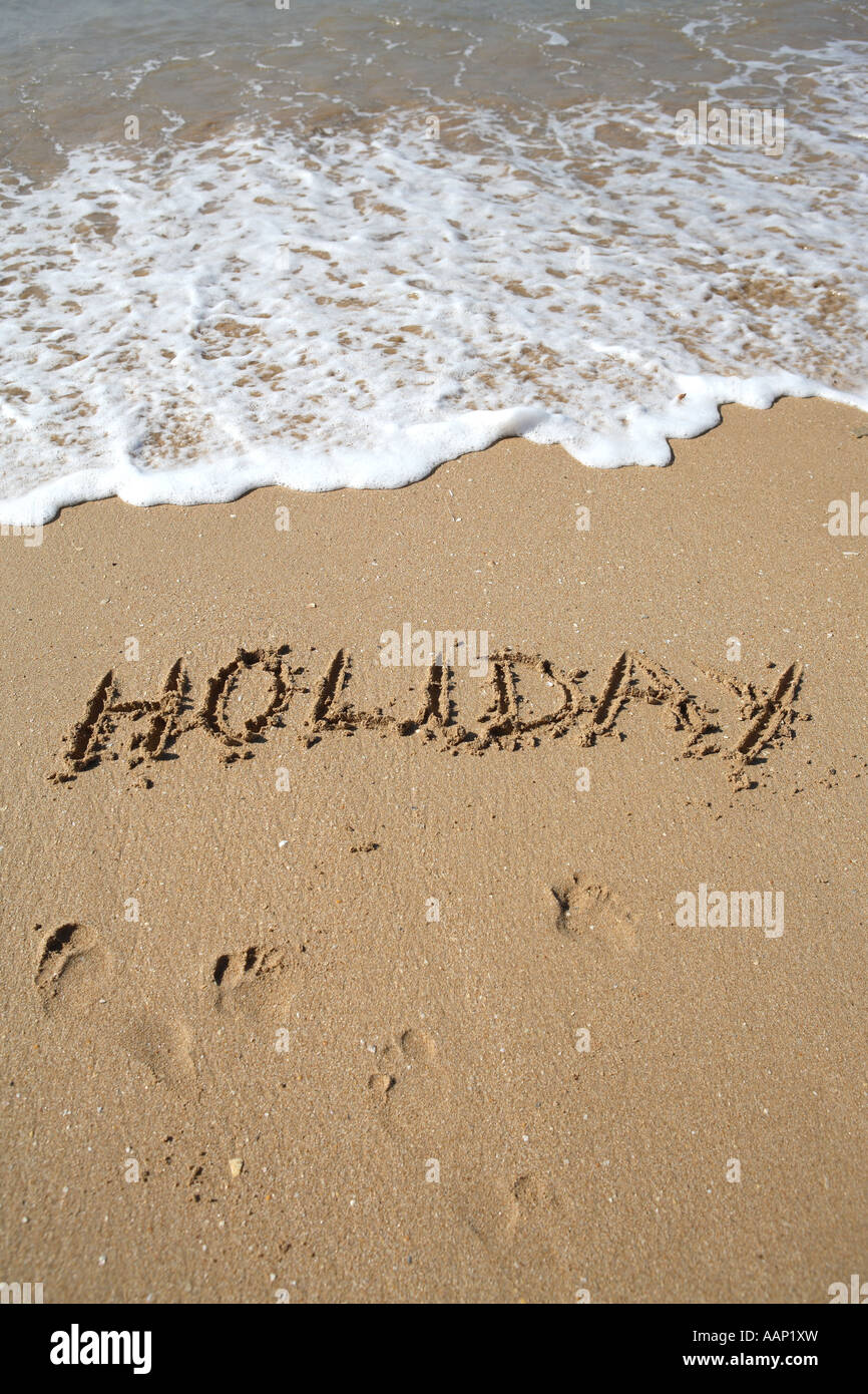 holiday written on sand Stock Photo - Alamy