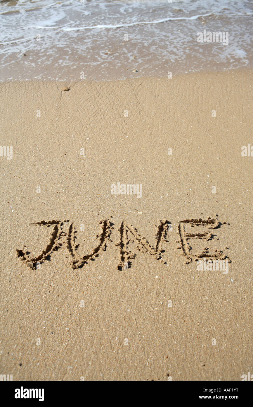 june written on sand, summer month Stock Photo - Alamy