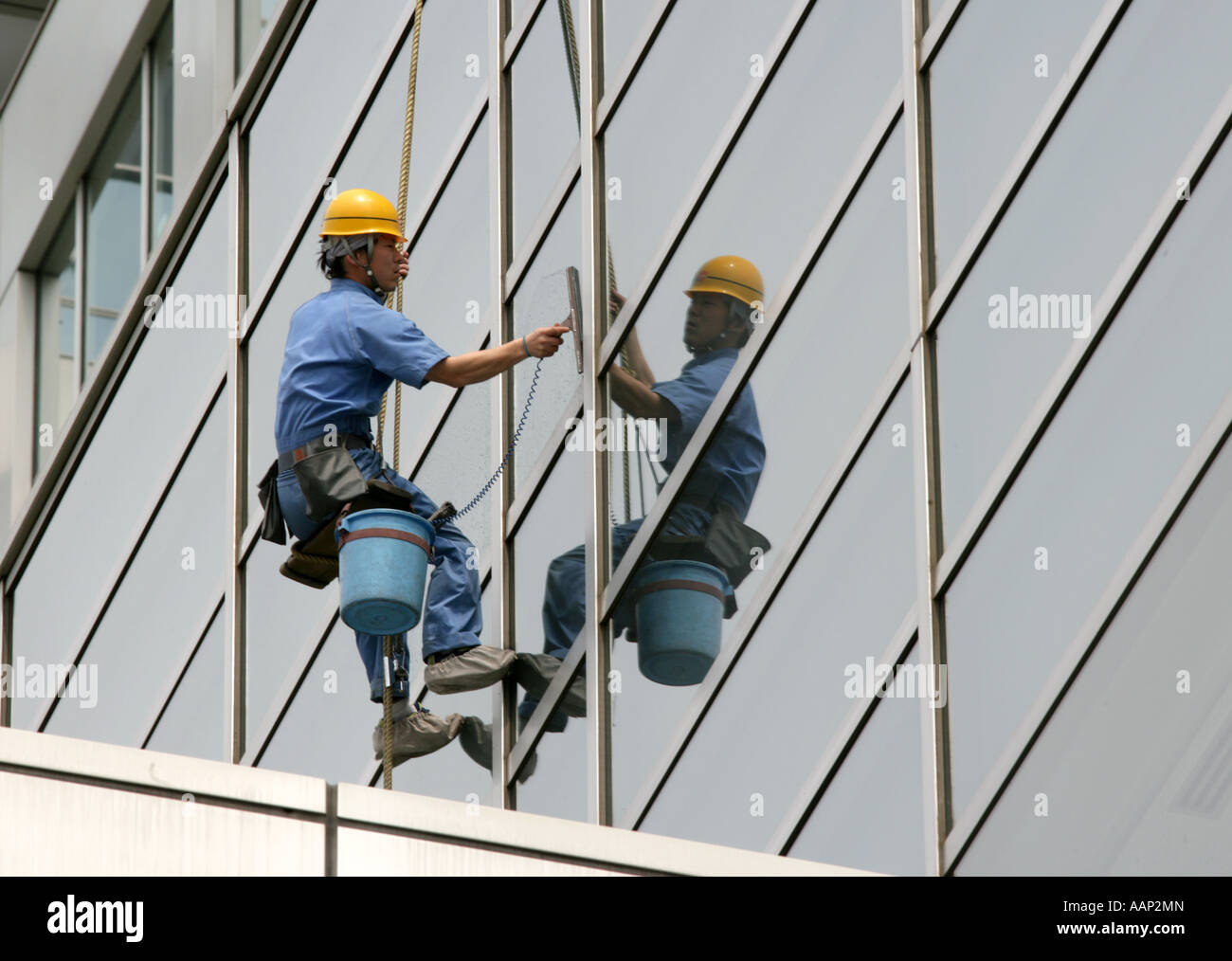 JPN, Japan, Tokyo: Window cleaner at the glass facade of a skyscraper ...