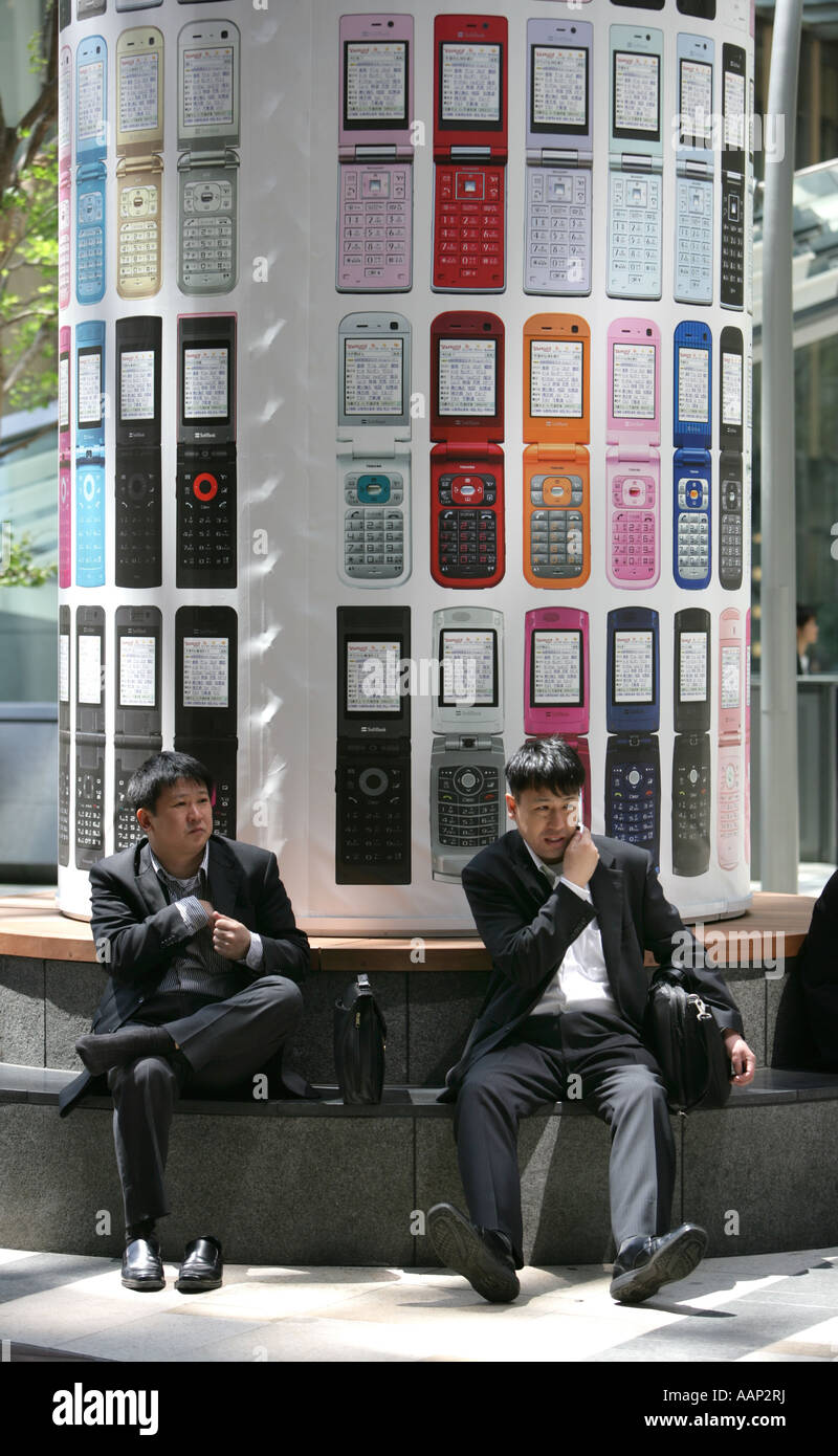JPN, Japan, Tokyo: Mobile phone user. Billboard of japanese provider ...