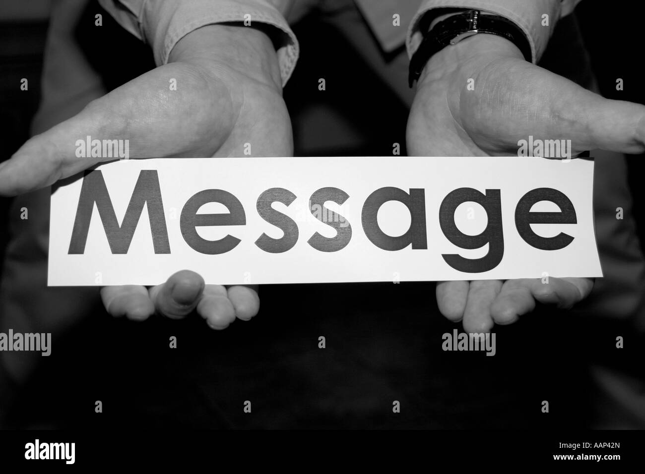The word message on a piece of paper being held in a persons hand ...