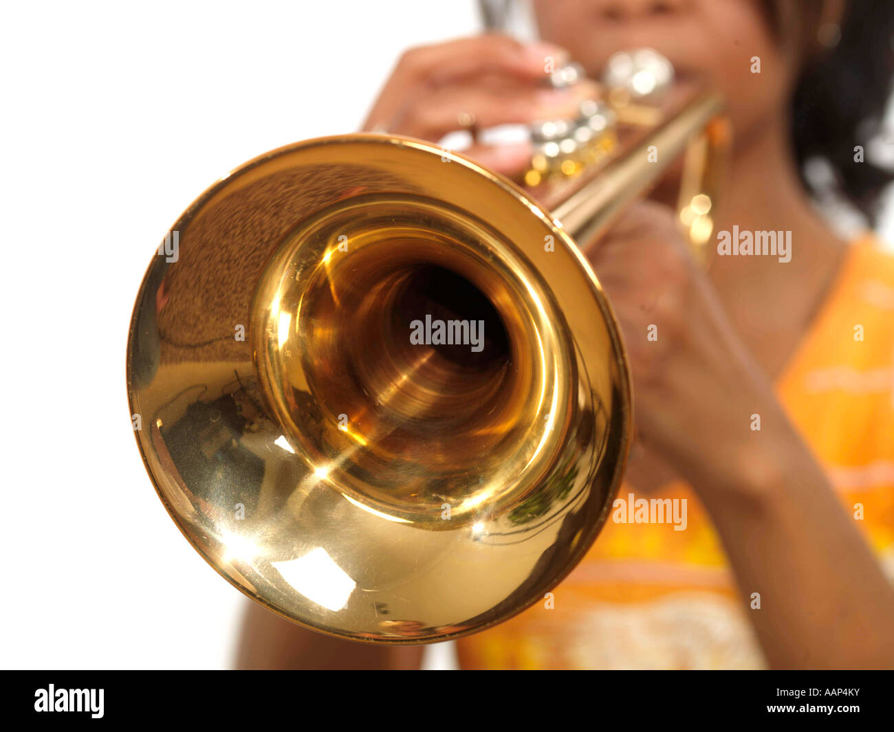 Young Confident Ethnic Woman Playing A Trumpet Isolated Against A White ...