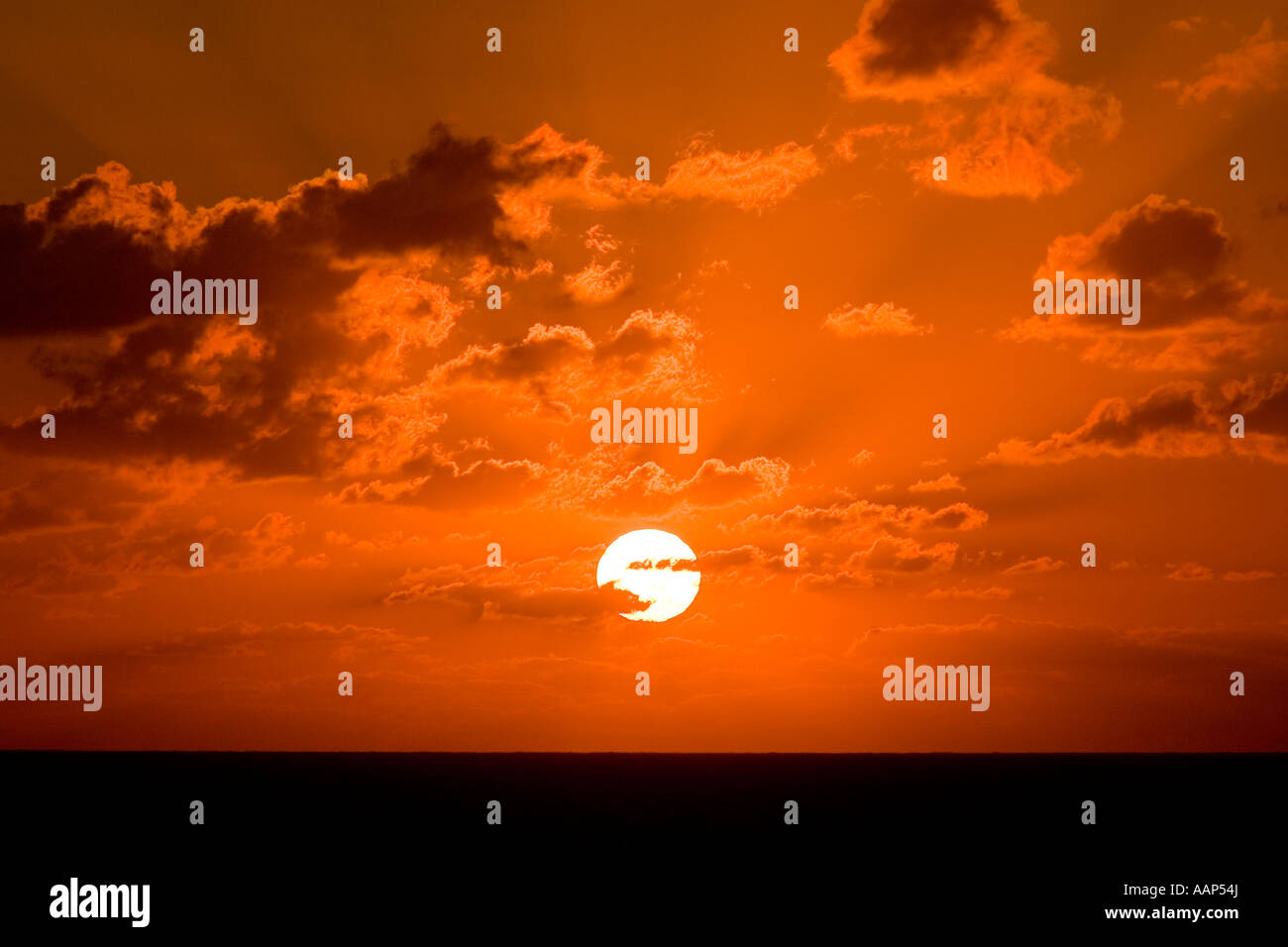 Orange Caribbean sunset Stock Photo - Alamy