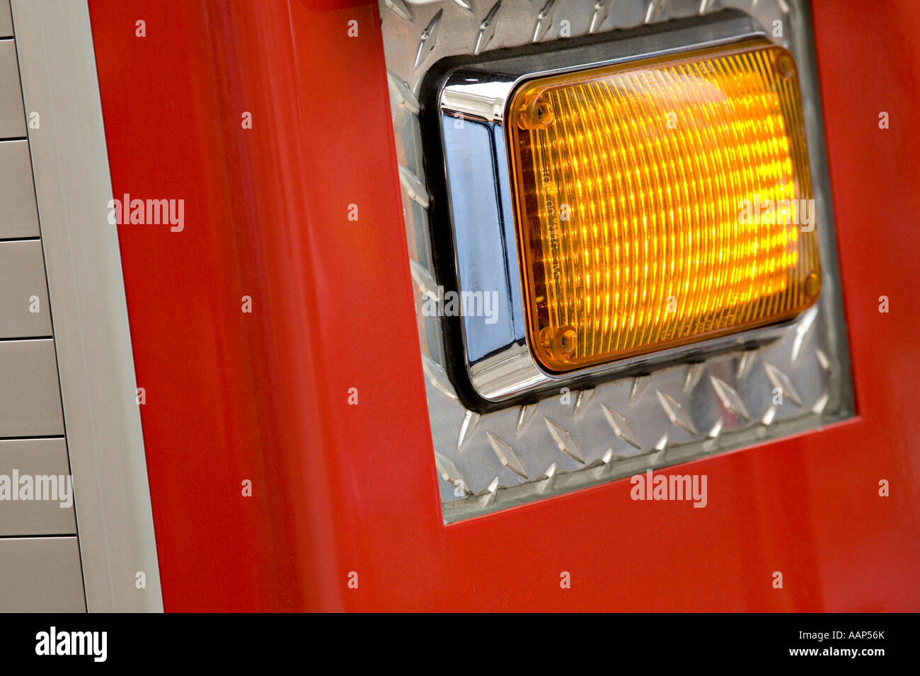 Amber flasher on a red firetruck Stock Photo - Alamy