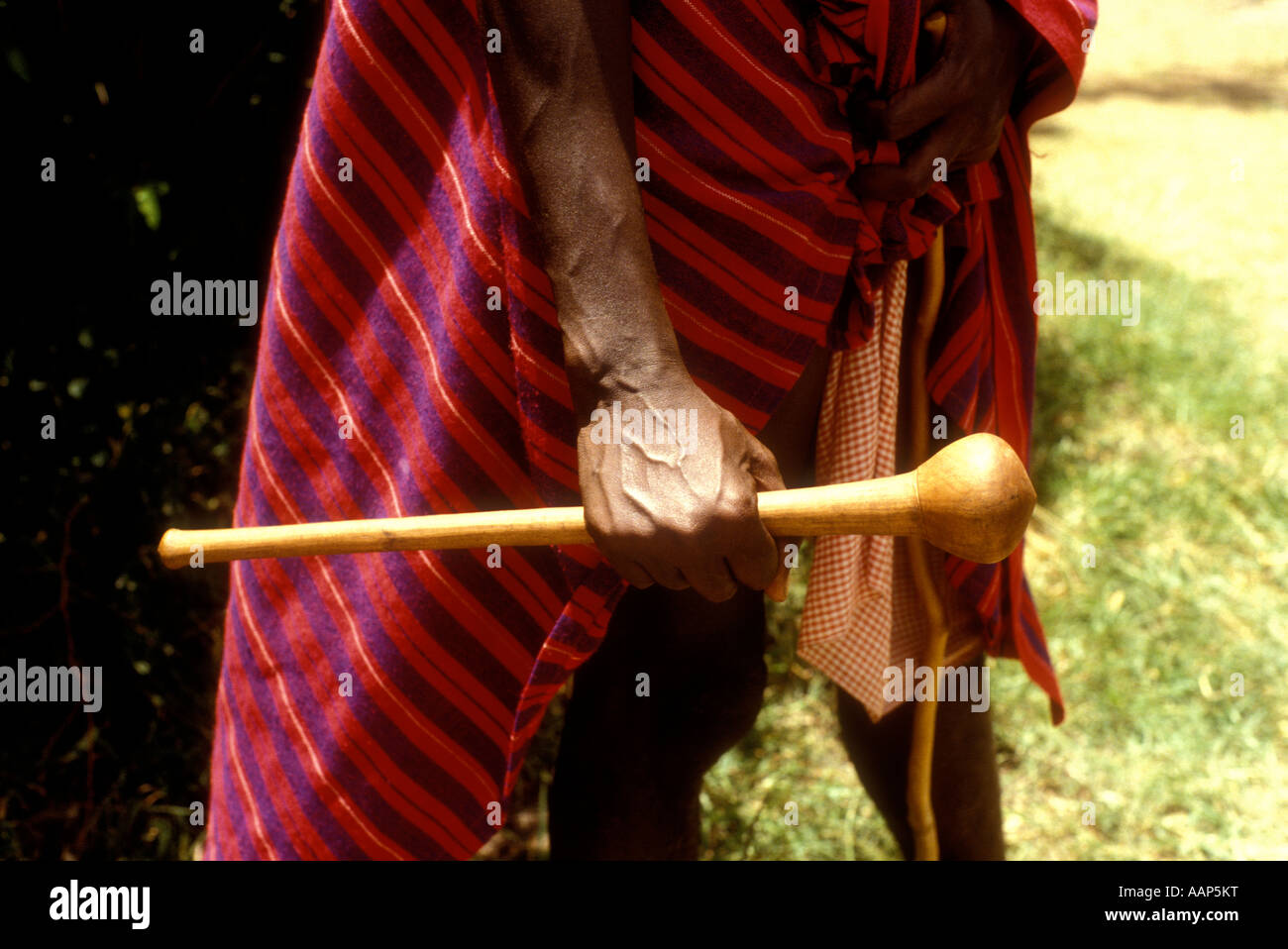 Close up of Maasai warrior s hand holding a traditional wooden rungu ...