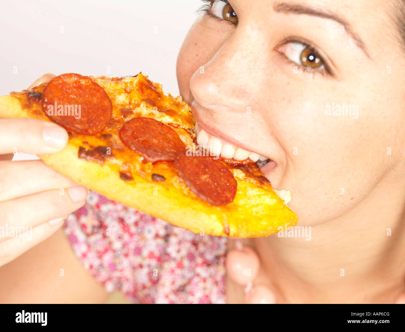 Young Woman Eating Pizza Model Released Stock Photo - Alamy