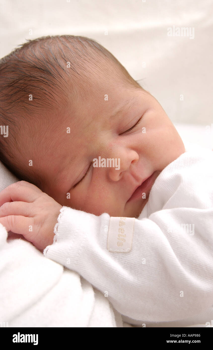 Smiling sleeping baby Stock Photo - Alamy