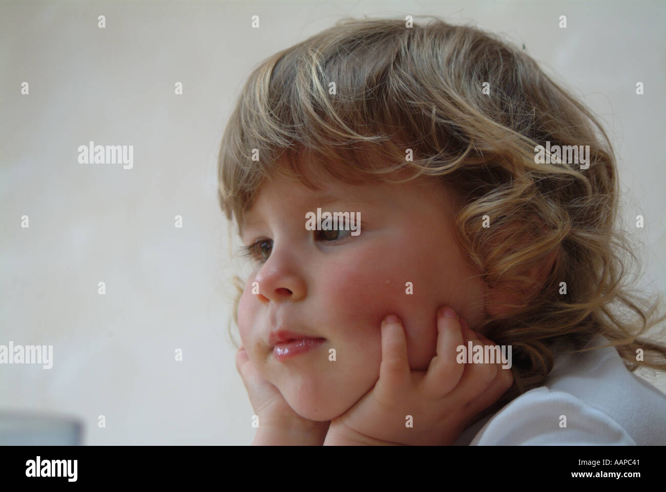 young child thinking with head on hands Stock Photo - Alamy