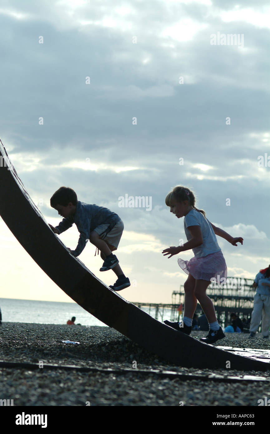 Children climbing on the Passacaglia sculpture on Brighton seafront ...