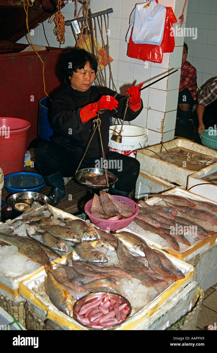 Trader weighing fish in indoor fish market, Cheung Chau Island, Hong ...