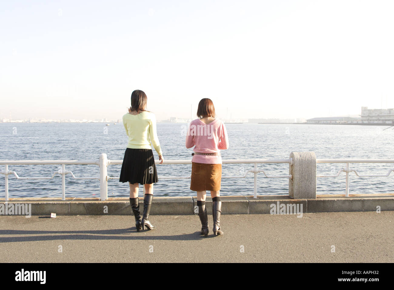 Woman standing seaside port hi-res stock photography and images - Alamy