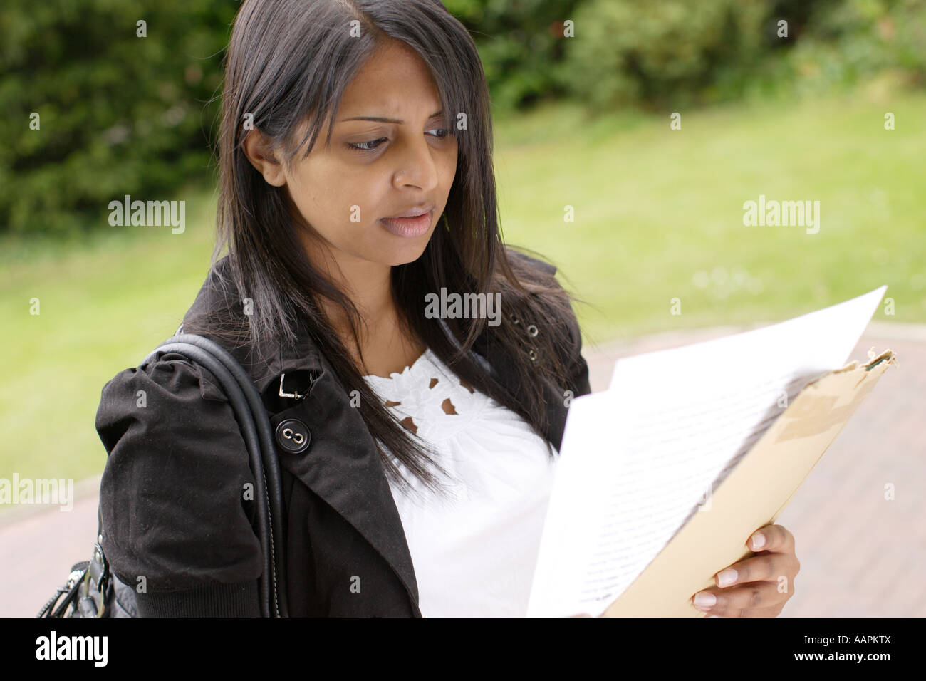Ethnic girl sat with exam results Stock Photo - Alamy