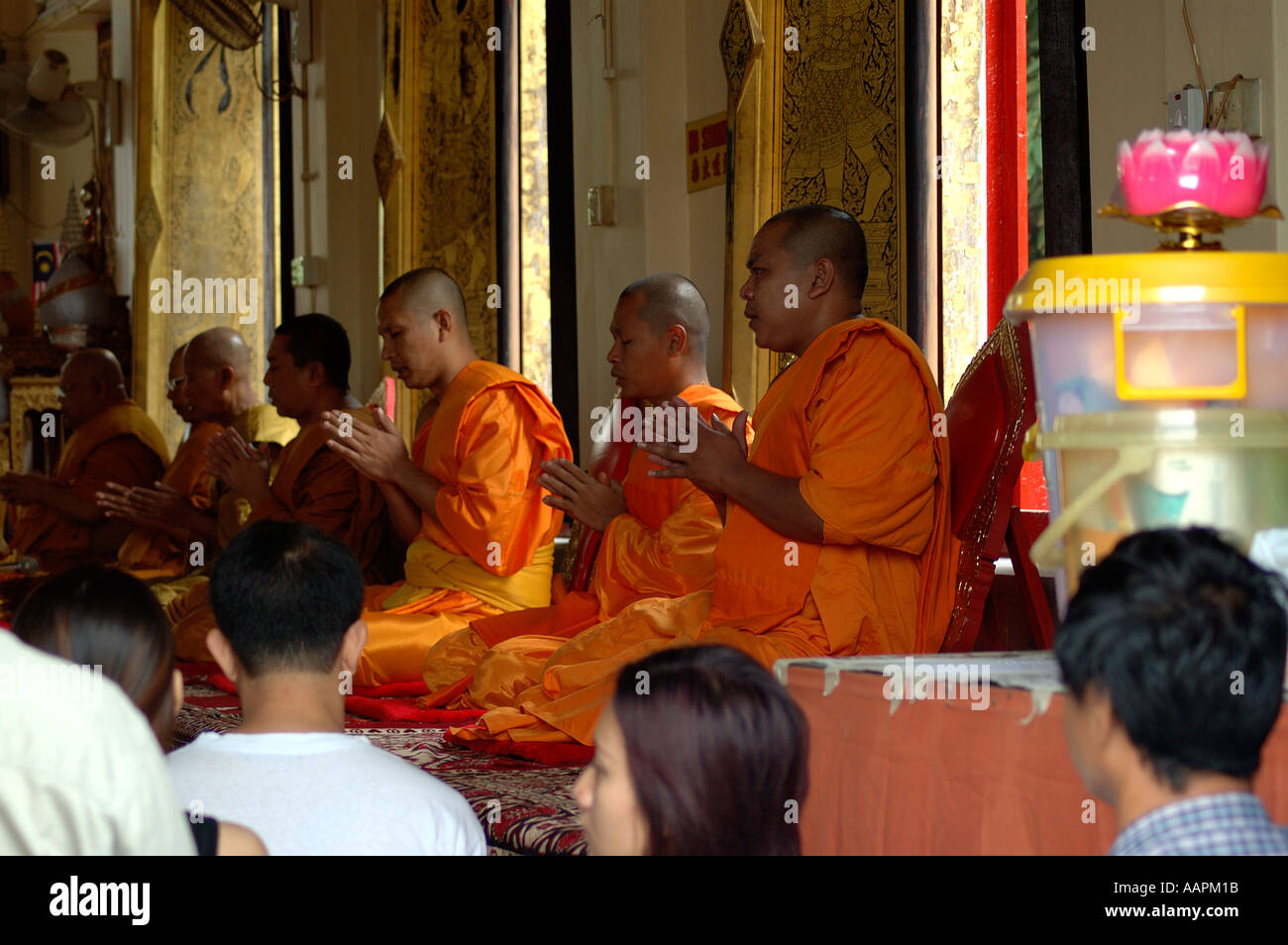Buddhist monks holding prayers Stock Photo - Alamy