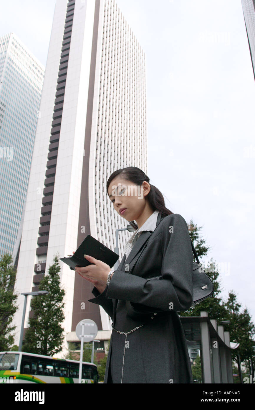 A young businesswoman checking schedule Stock Photo - Alamy