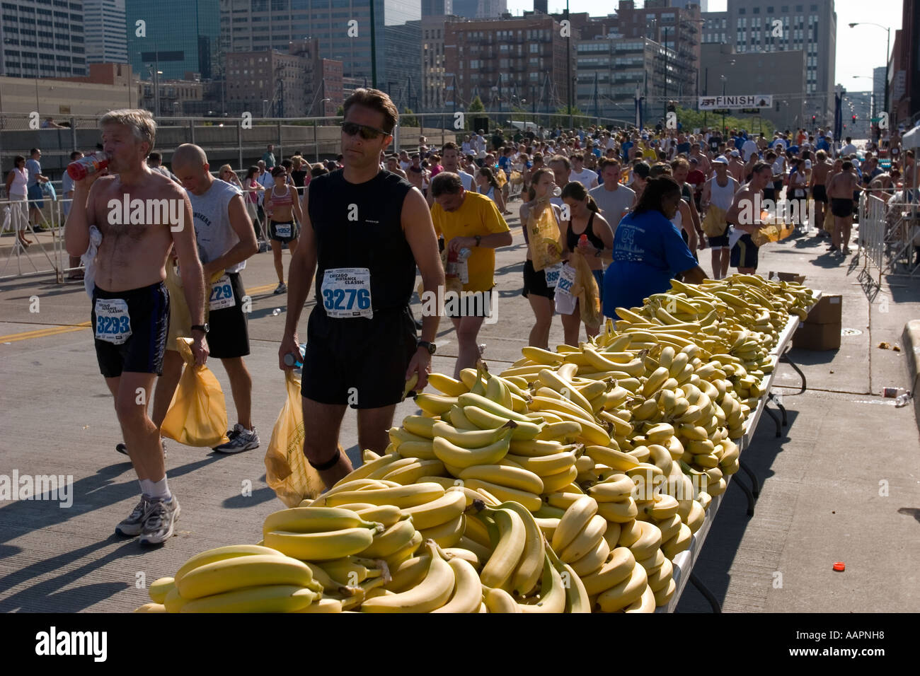 Marathon competitors at table of bananas near finish line of Chicago ...