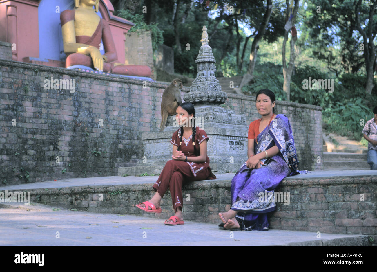 Nepali girl and woman sitting on stairs leading to Swayambhunath Temple ...