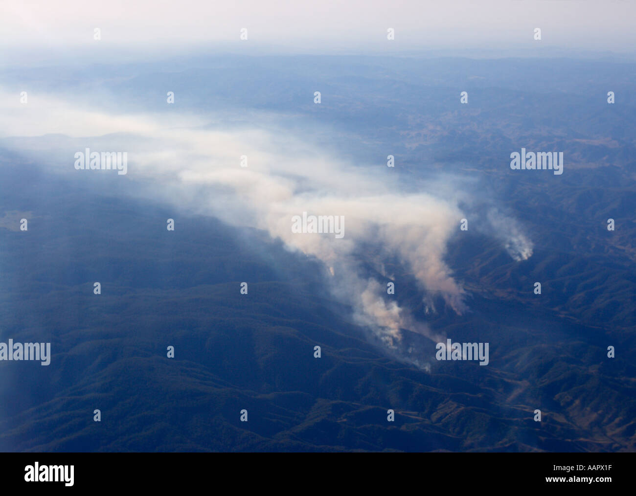 Aerial view of bush fire burning on several fronts giving out a huge ...
