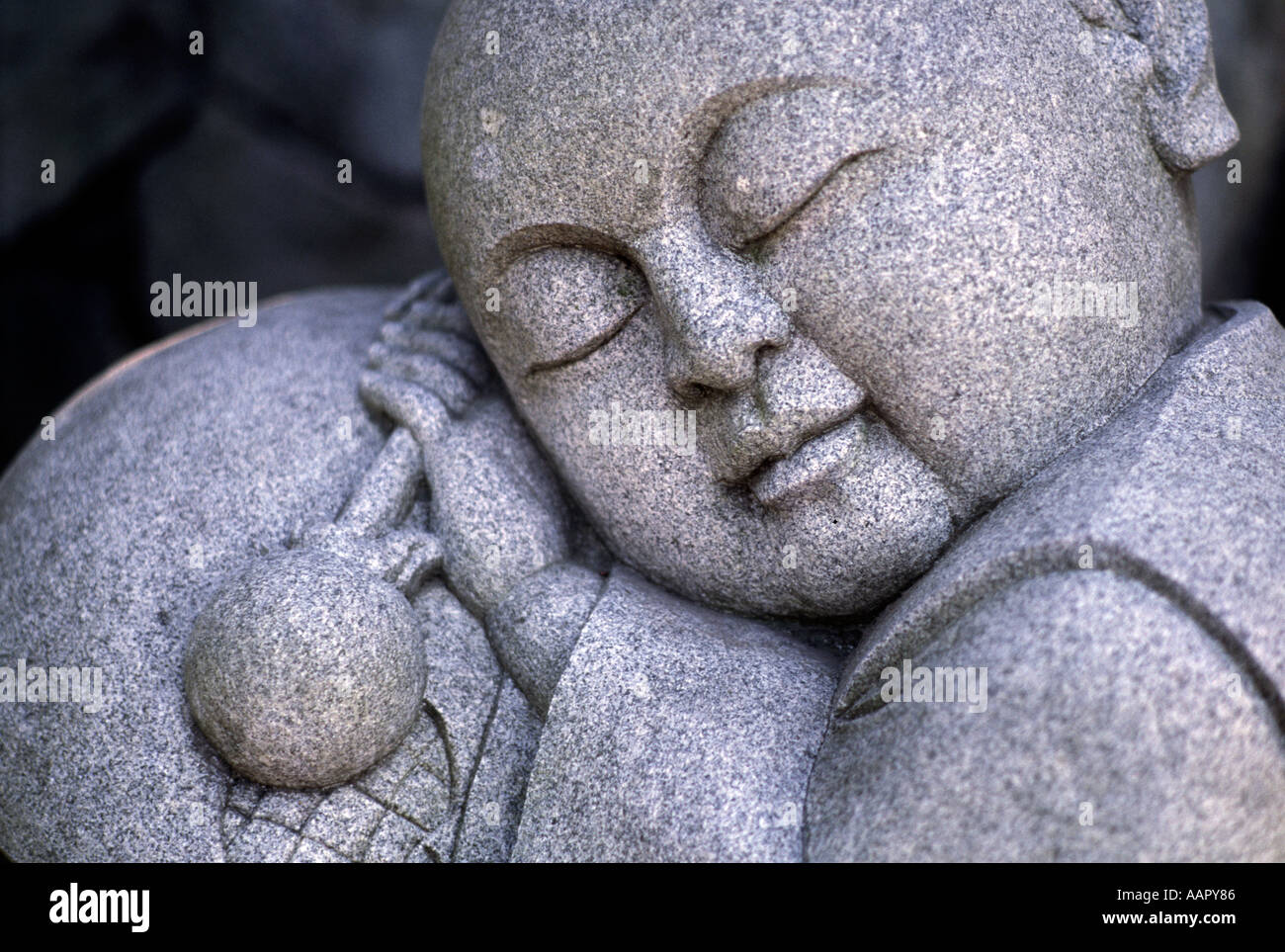 Carved stone statue of a child beating a drum at KoyaSan Mount Koya ...