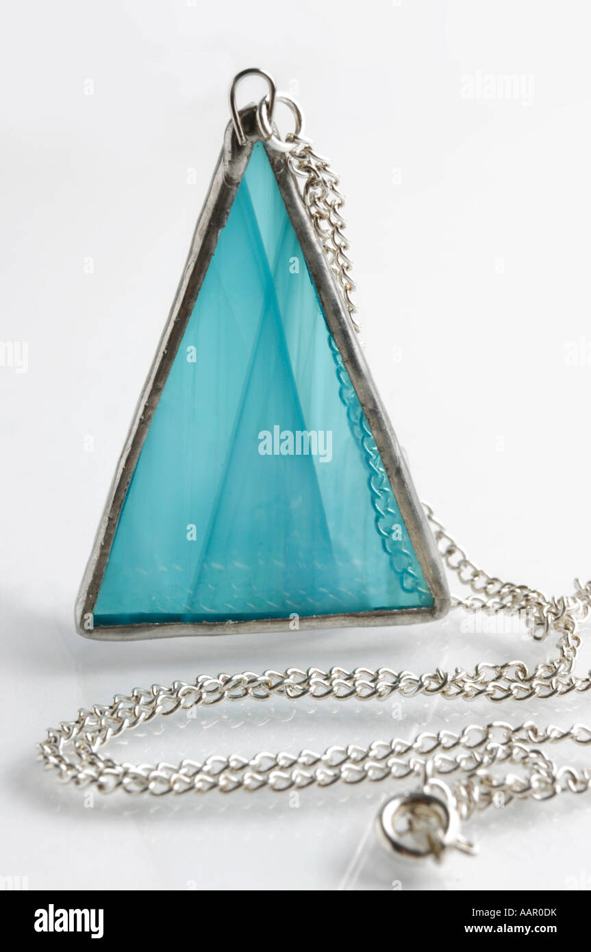 Necklace with a blue triangle gem on a chain Isolated on white cutout ...